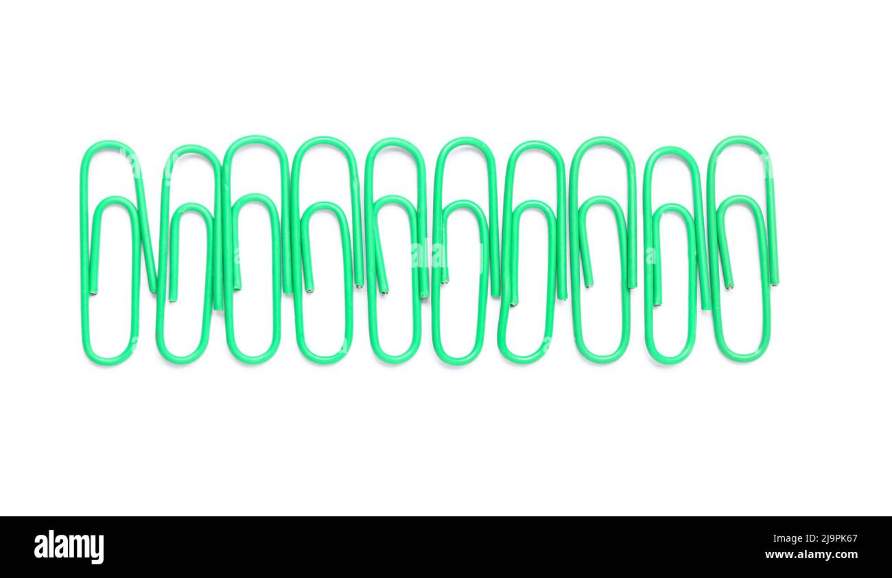 Green paper clips on white background Stock Photo - Alamy