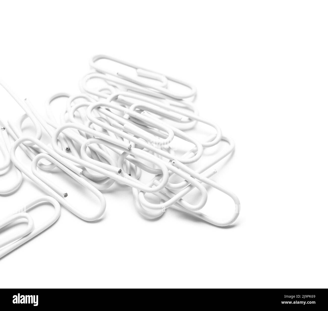 Many paper clips on white background Stock Photo - Alamy