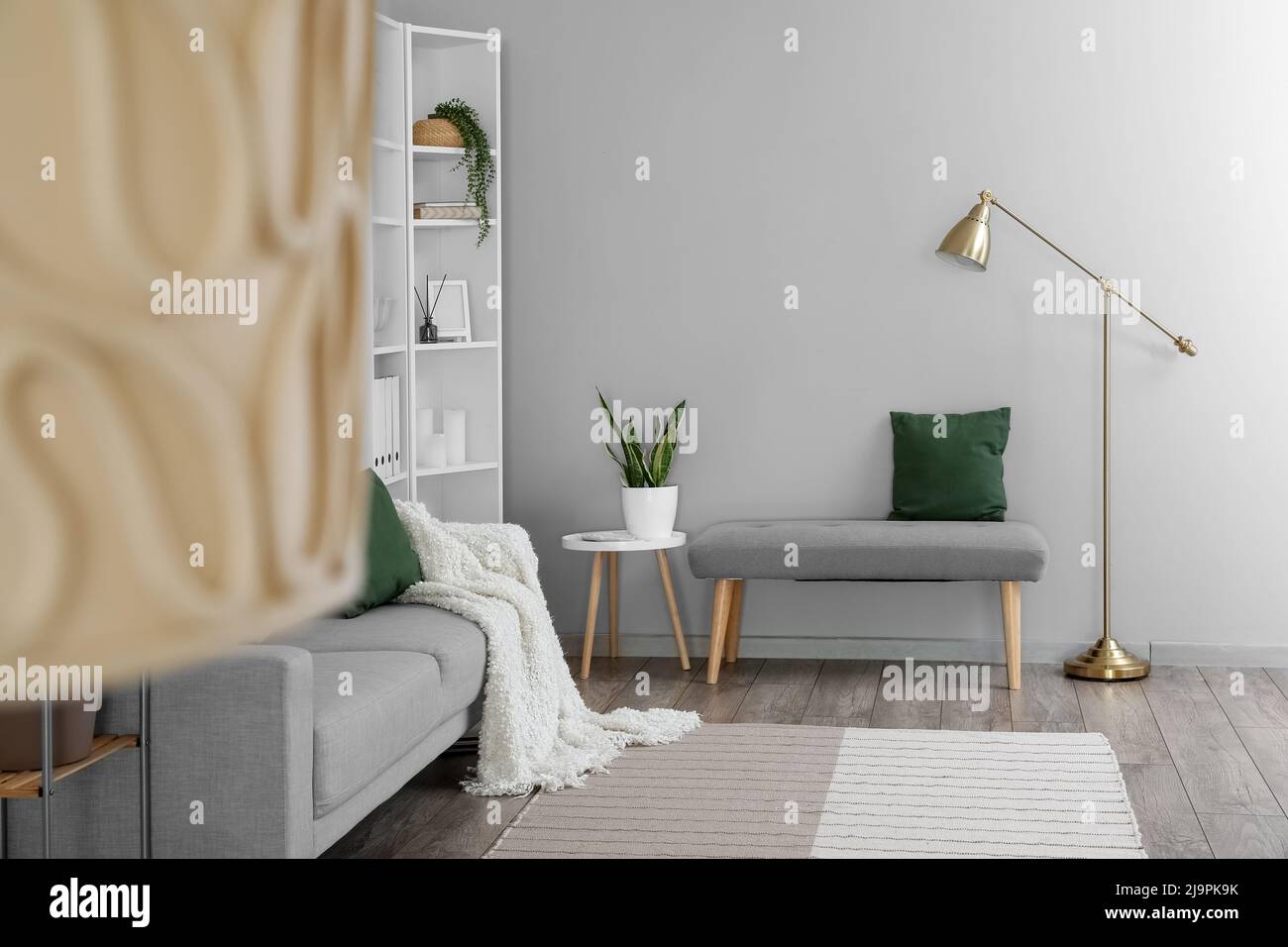 Interior of light living room with soft bench, sofa and lamp Stock ...