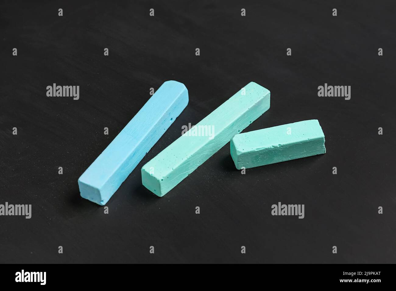 Pieces of blue chalk on blackboard Stock Photo - Alamy