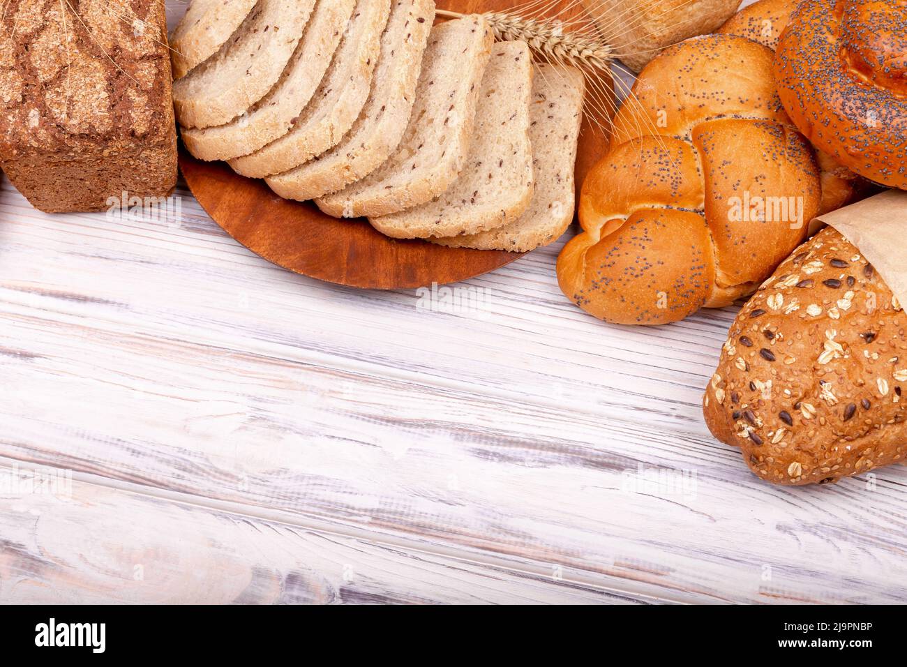 Composition with bread with crispy crust , rolls on white background ...
