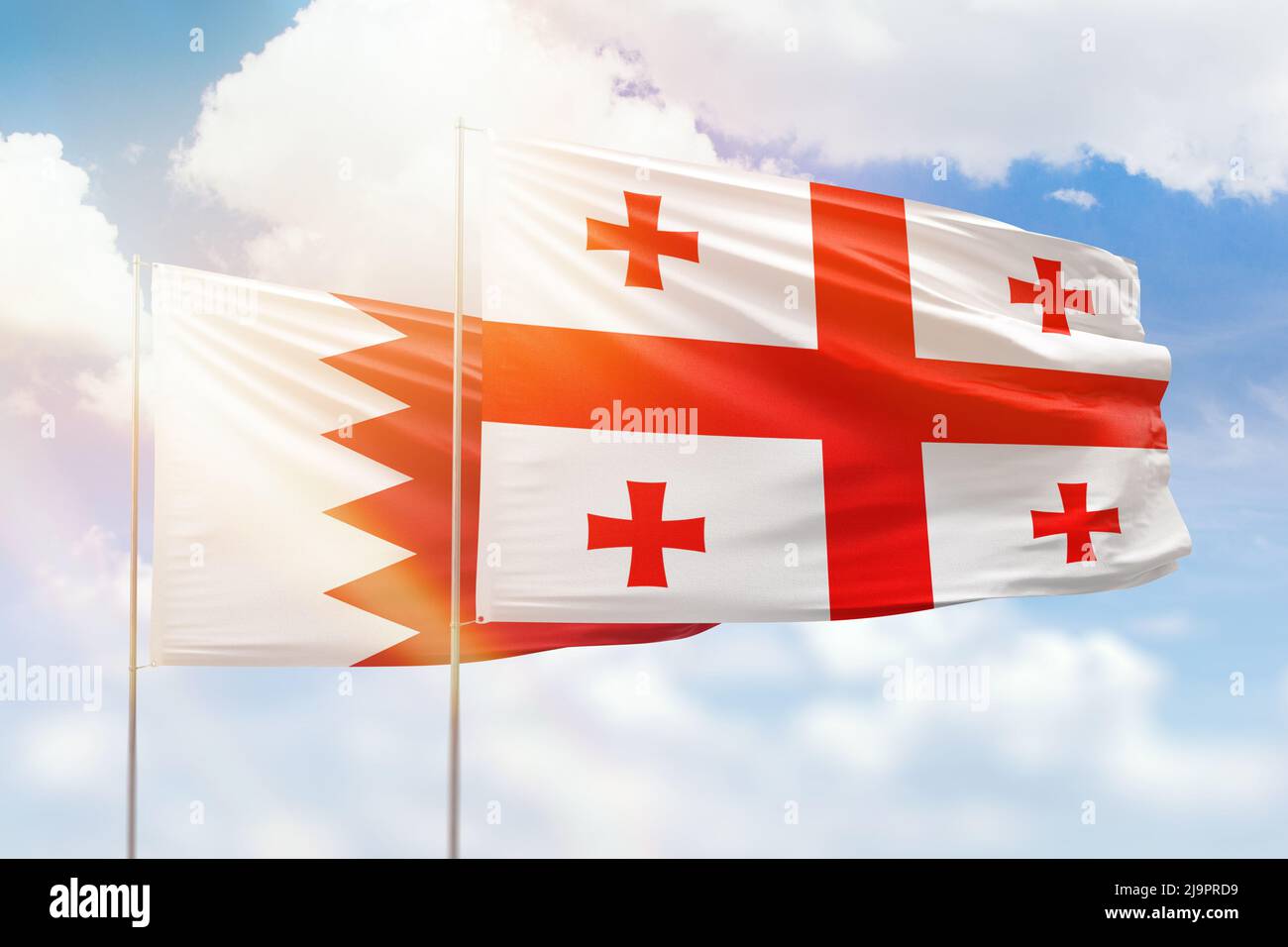 Sunny blue sky and flags of georgia and bahrain Stock Photo - Alamy