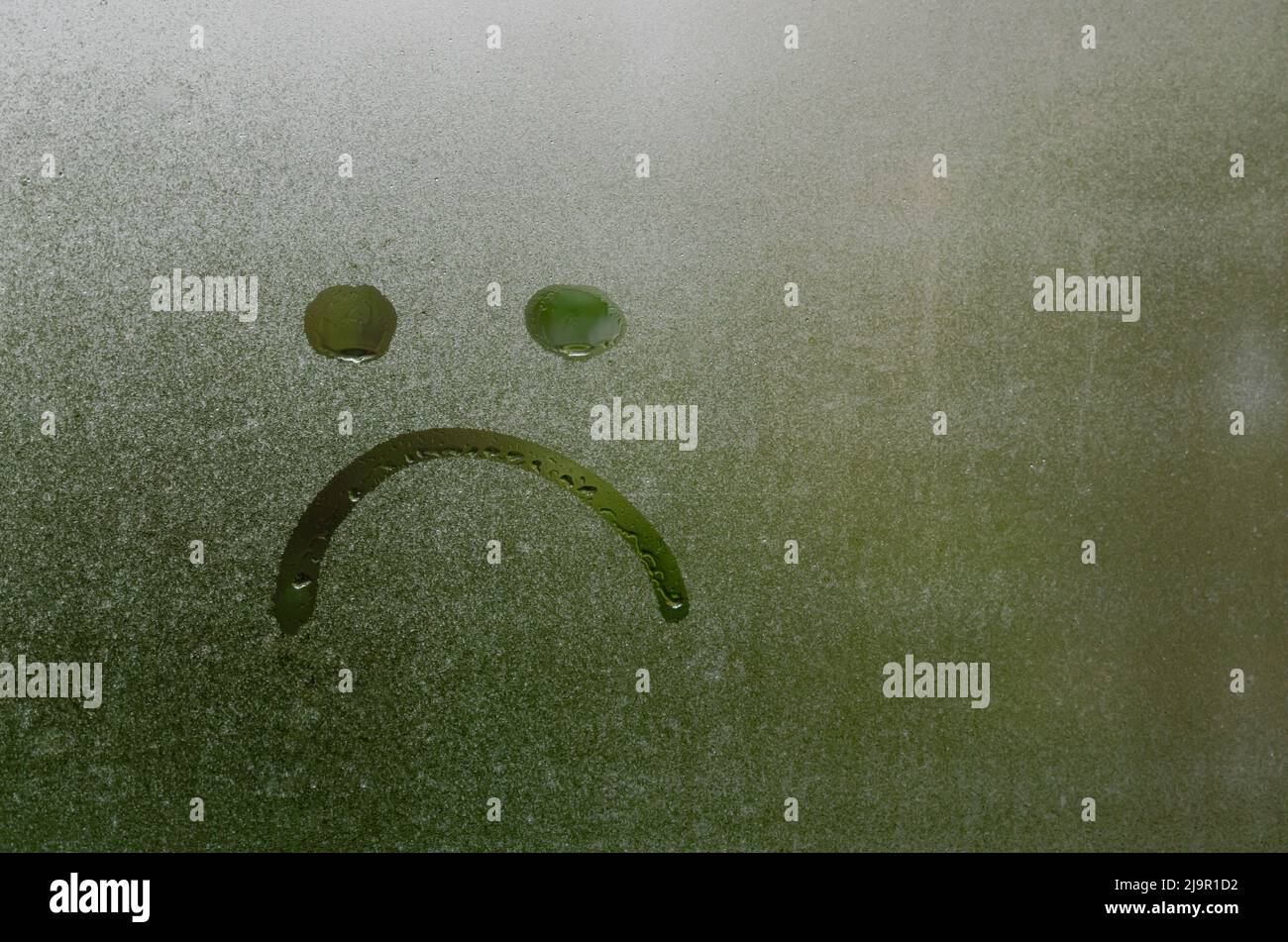 Face expession as boring and sad painted on window which fogged up ...