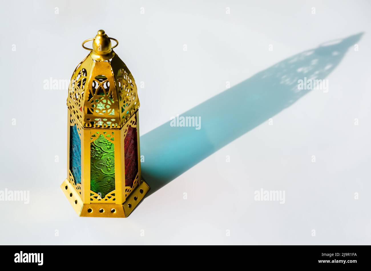 Golden lantern with shadow from sun light on white background Stock ...