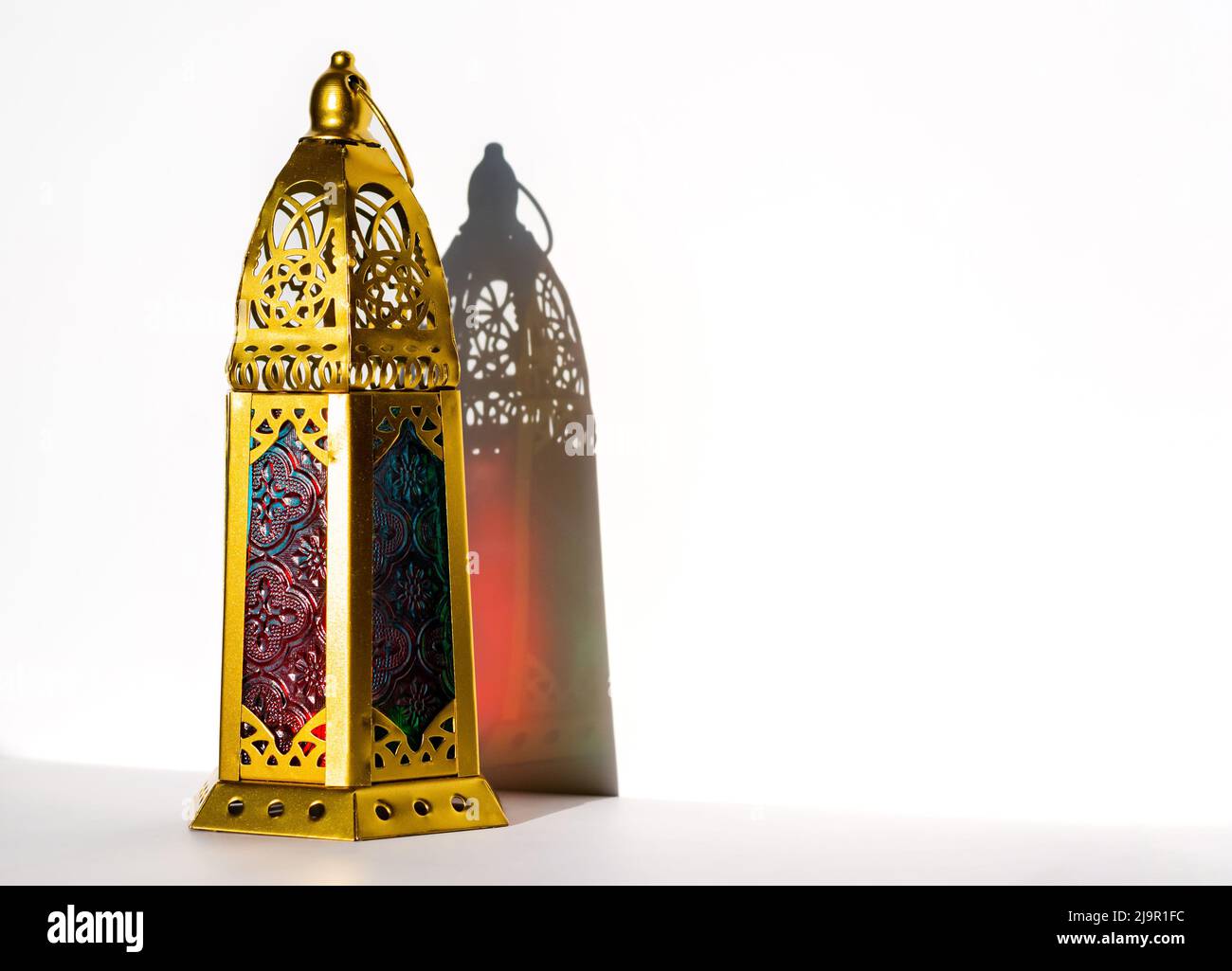 Golden lantern with shadow from sun light on white background Stock ...