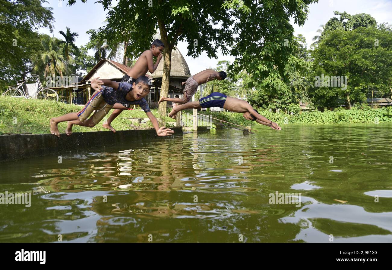 Guwahati, Guwahati, India. 24th May, 2022. Village youth cool itself by ...