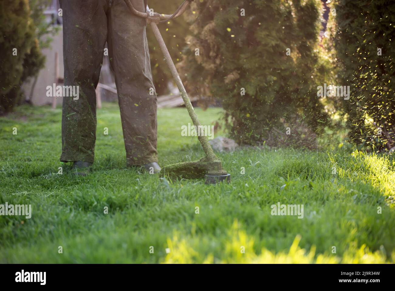 Mowing the grass with a lawn mower. Garden work concept background ...