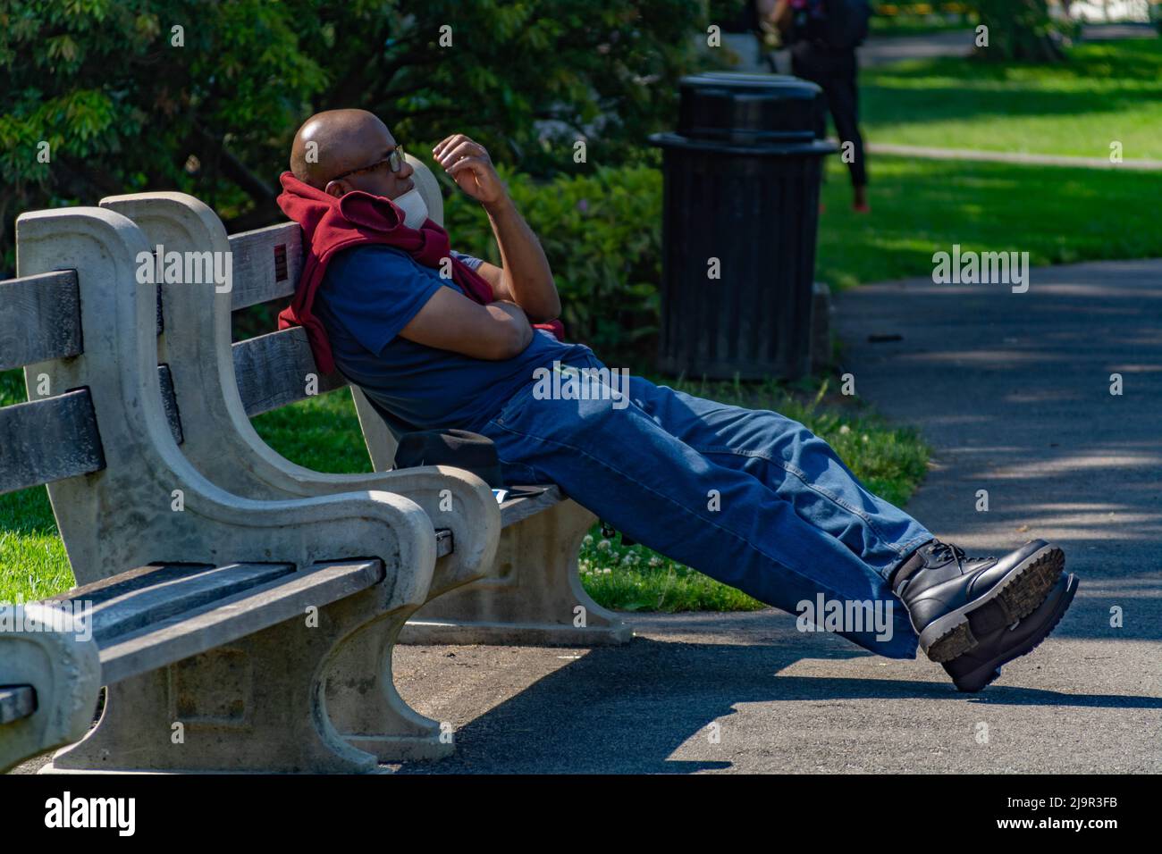 An African American man is resting on the bench in the Brooklyn ...