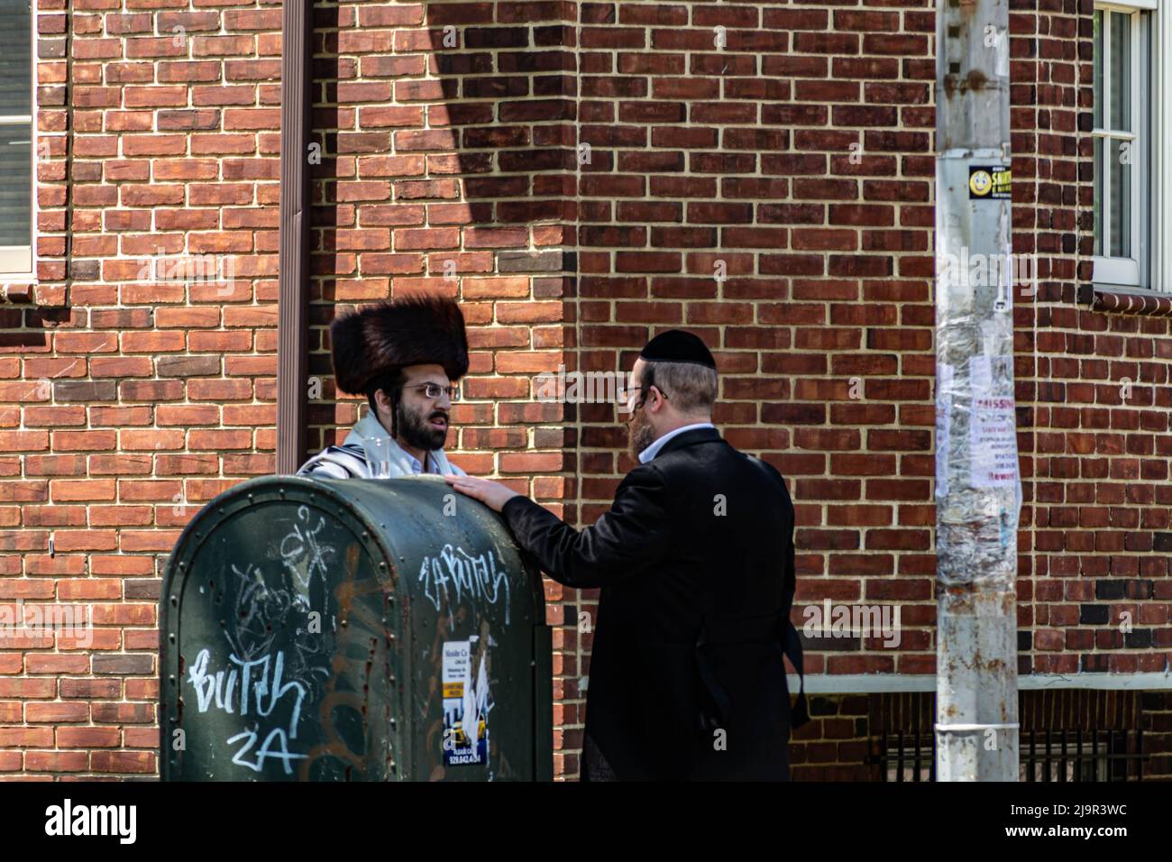 Two Jewish man standing and talking on the street Stock Photo - Alamy