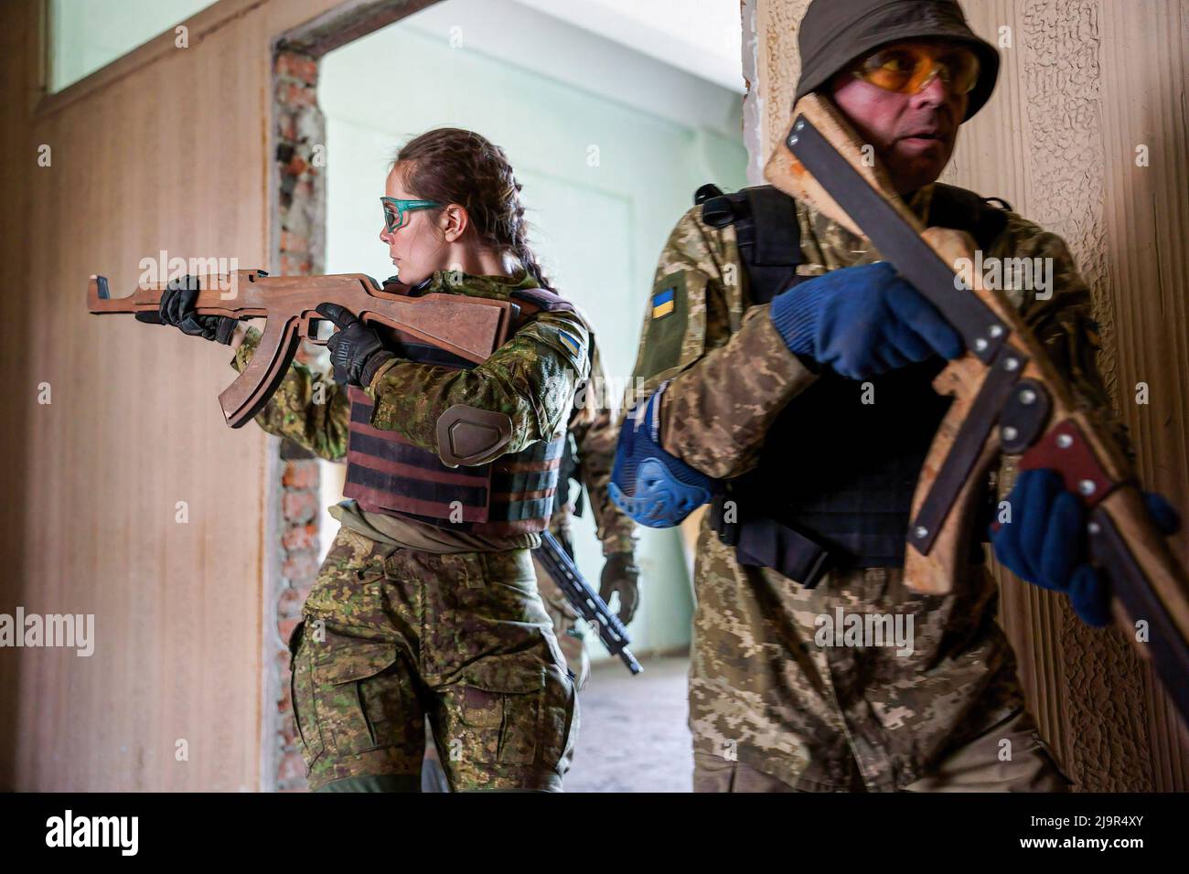 Two soldiers carrying simulation firearms conduct a room clearance ...