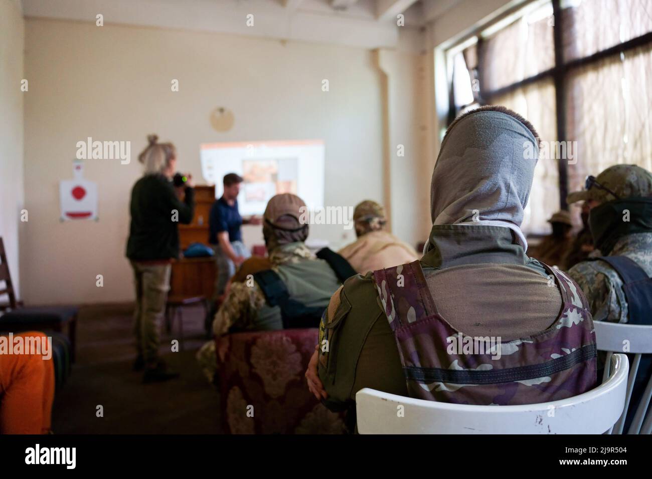 A military officer listens to the handler instructing trainees on the ...