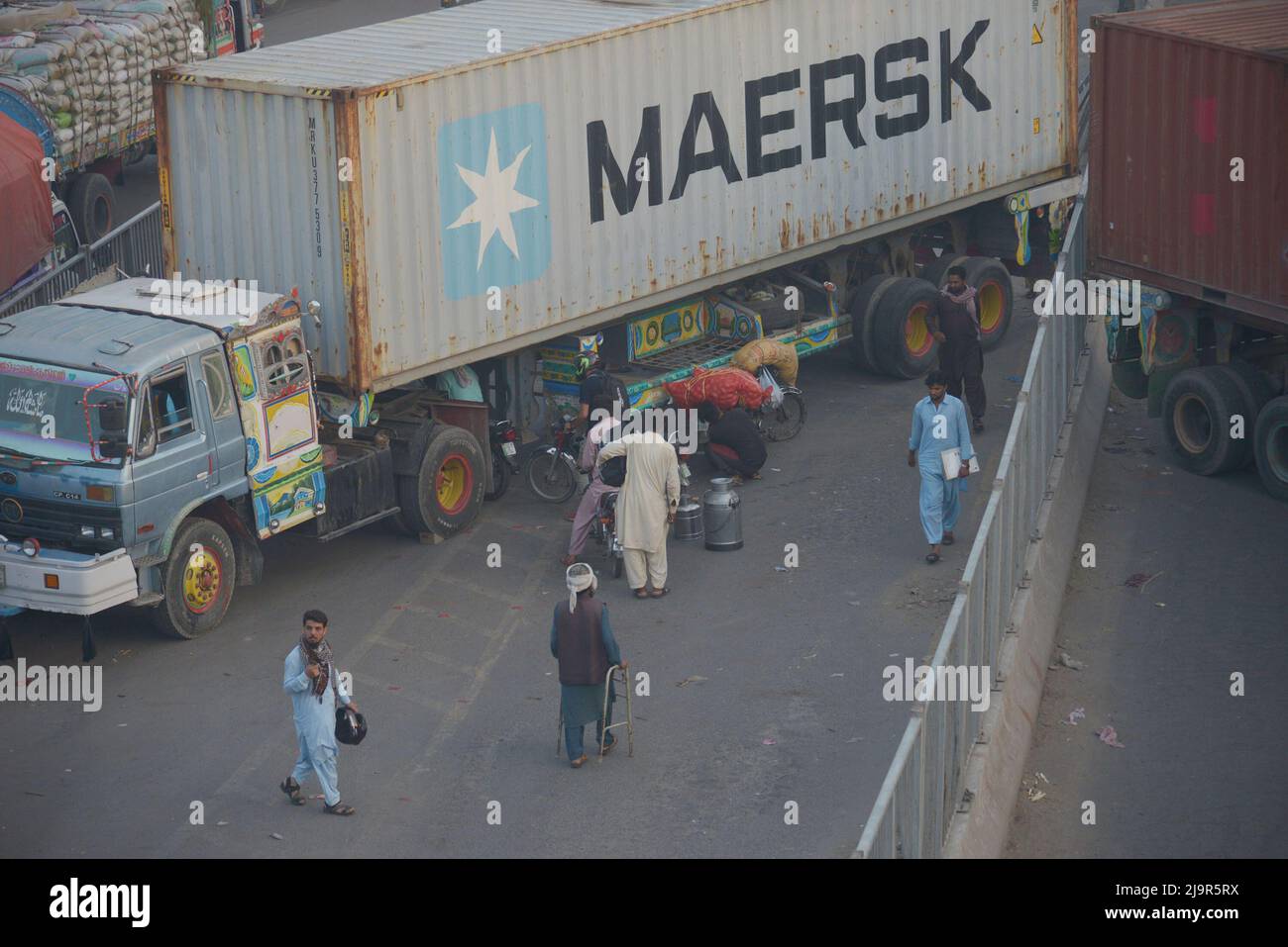 Pakistani commuters and drivers sleeping in their vehicle on a bridge ...