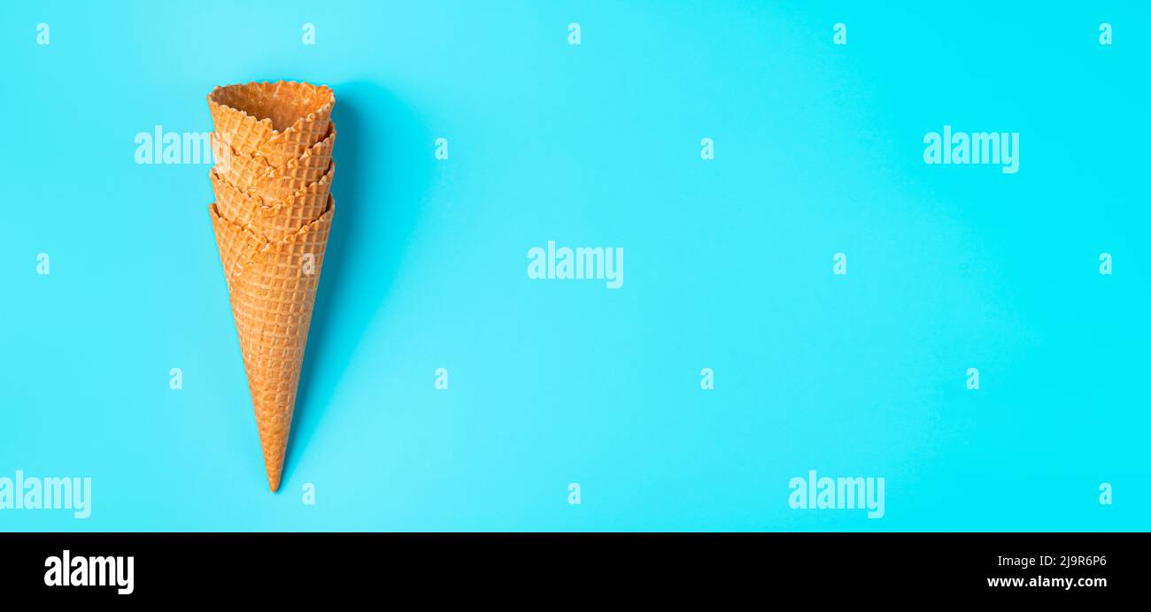 A stack of waffle ice cream cups on a light blue background Stock Photo ...