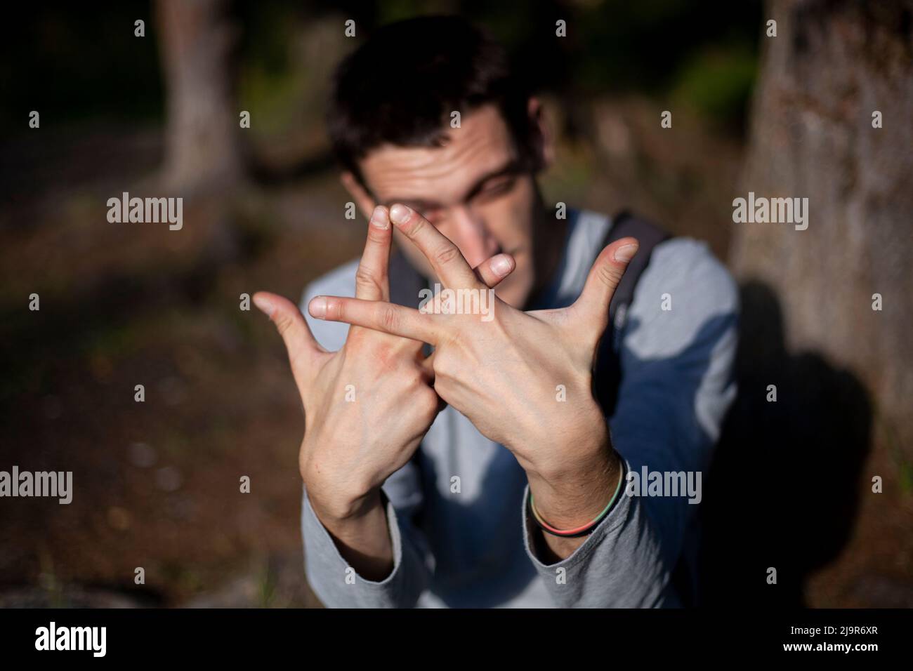 A young man shows gestures with his hands. The guy shows movements with ...