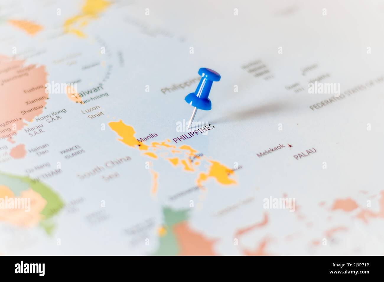Blue push pin pointing at Philippines on a political world map Stock ...