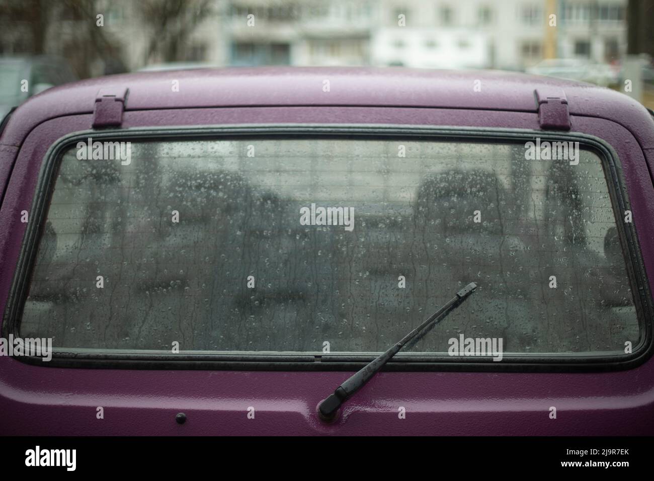 Car window is lighter in rain. Wet car in parking lot. Details of old ...