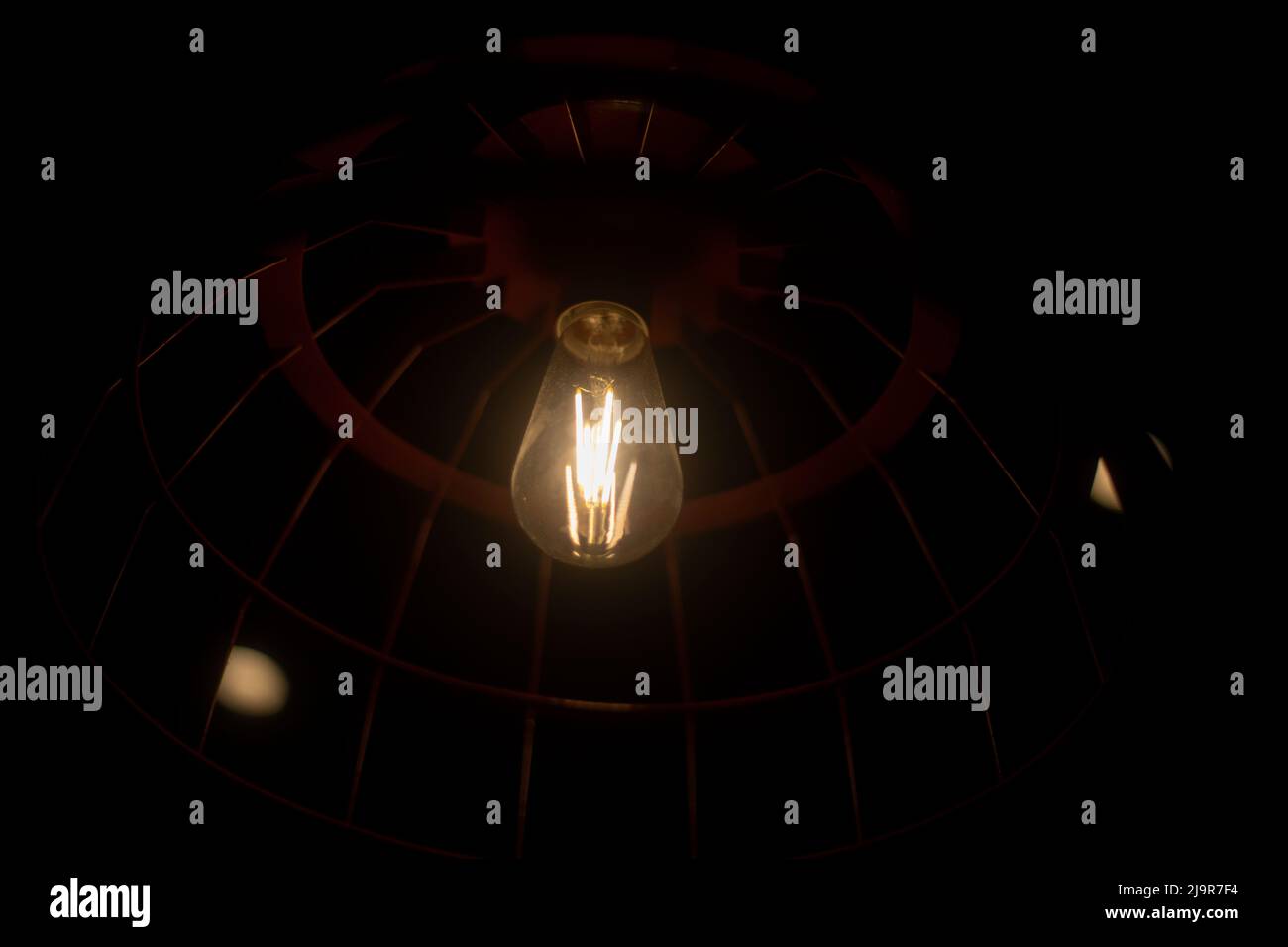 Lamp in dark. Incandescent lamp shines yellow. Details of design of ...