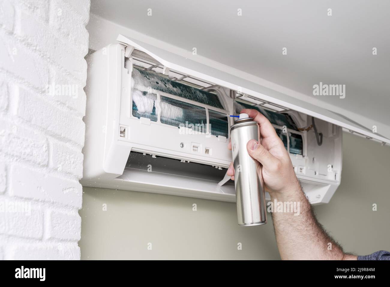 air conditioner cleaning with spray foam cleaner Stock Photo - Alamy