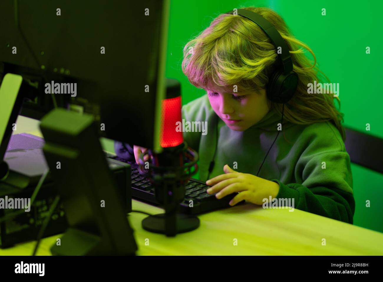 Little hacker, young programmer. Child with pc computer at night ...