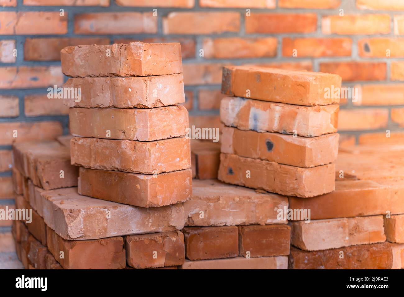 Red ceramic bricks stacked close up at a construction site. building ...