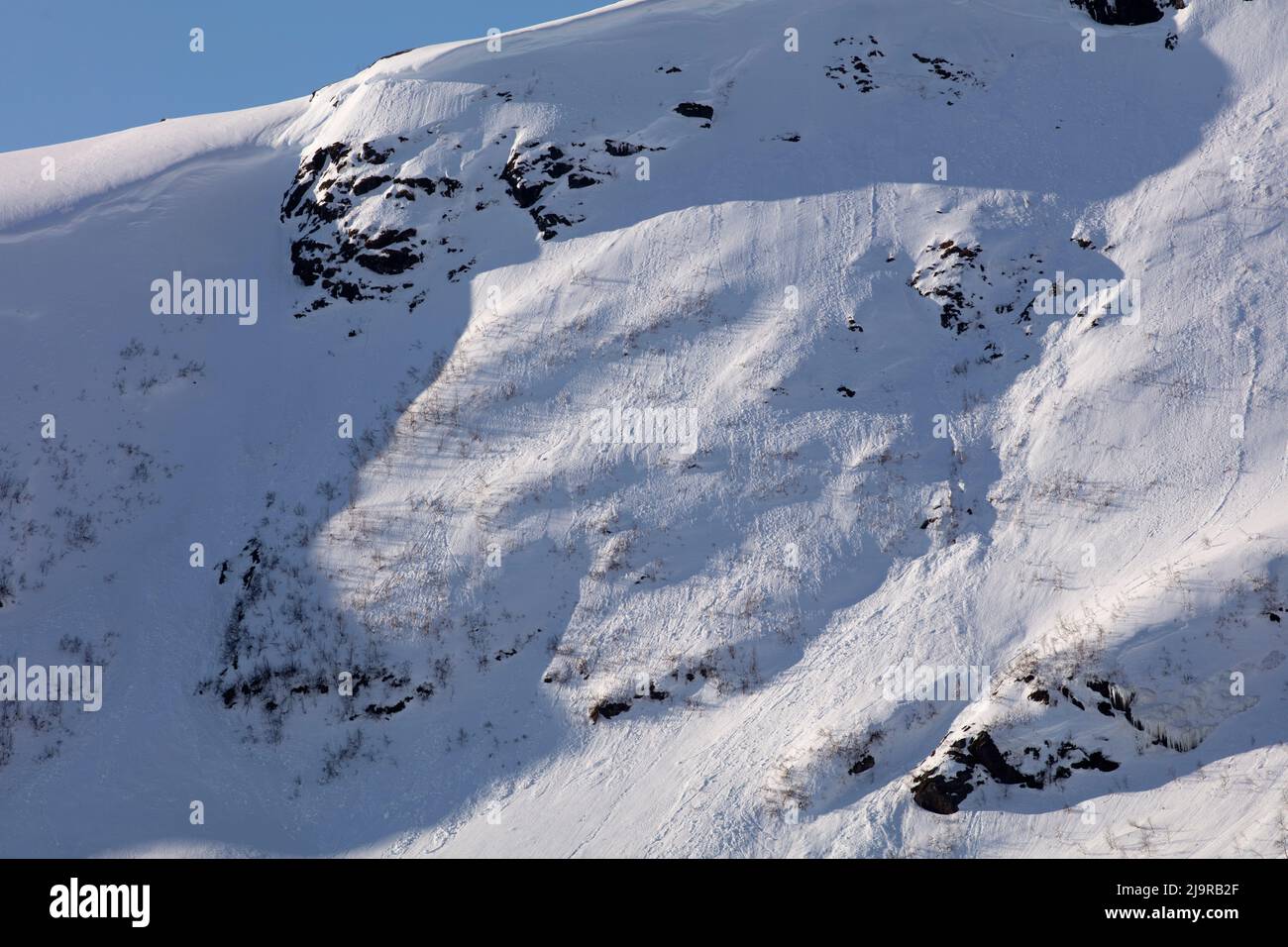 Scandinavian Mountains in March. Bright sunshine, thaw on the hillside ...