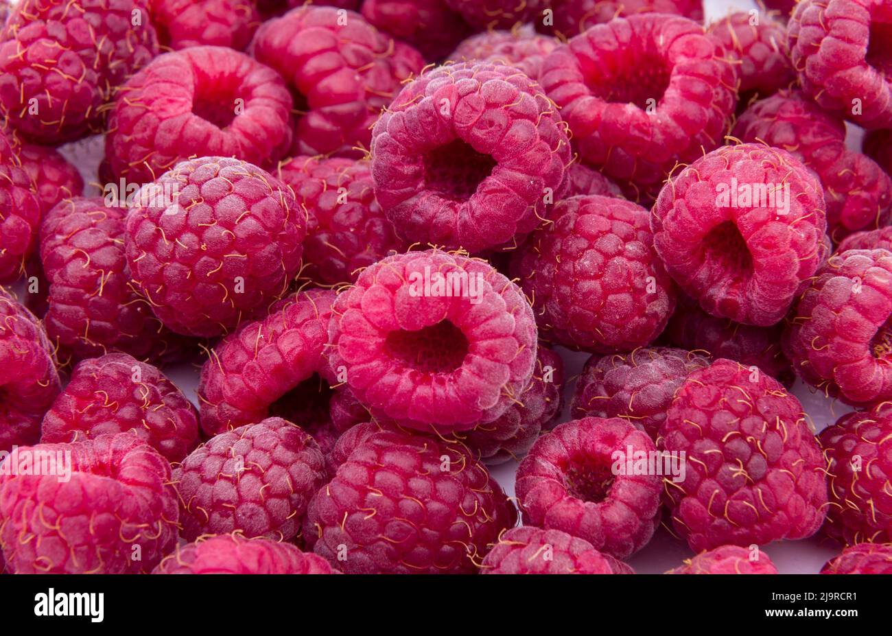 Raspberries background red berry texture pattern Stock Photo - Alamy