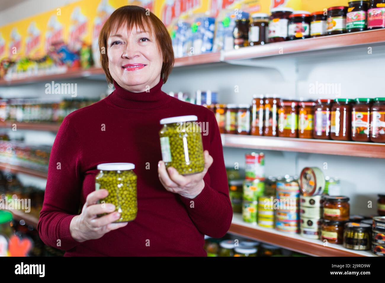 cheerful woman with canned jar of peas Stock Photo - Alamy