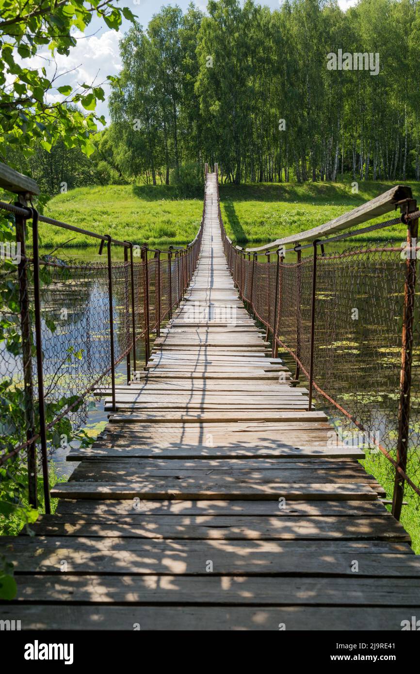 Hanging bridge goes over river Stock Photo - Alamy