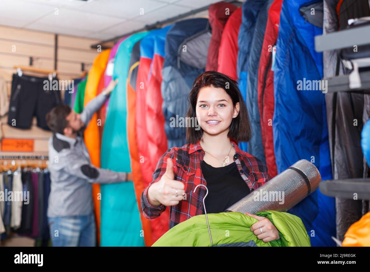 Couple examining touristic equipment items Stock Photo - Alamy