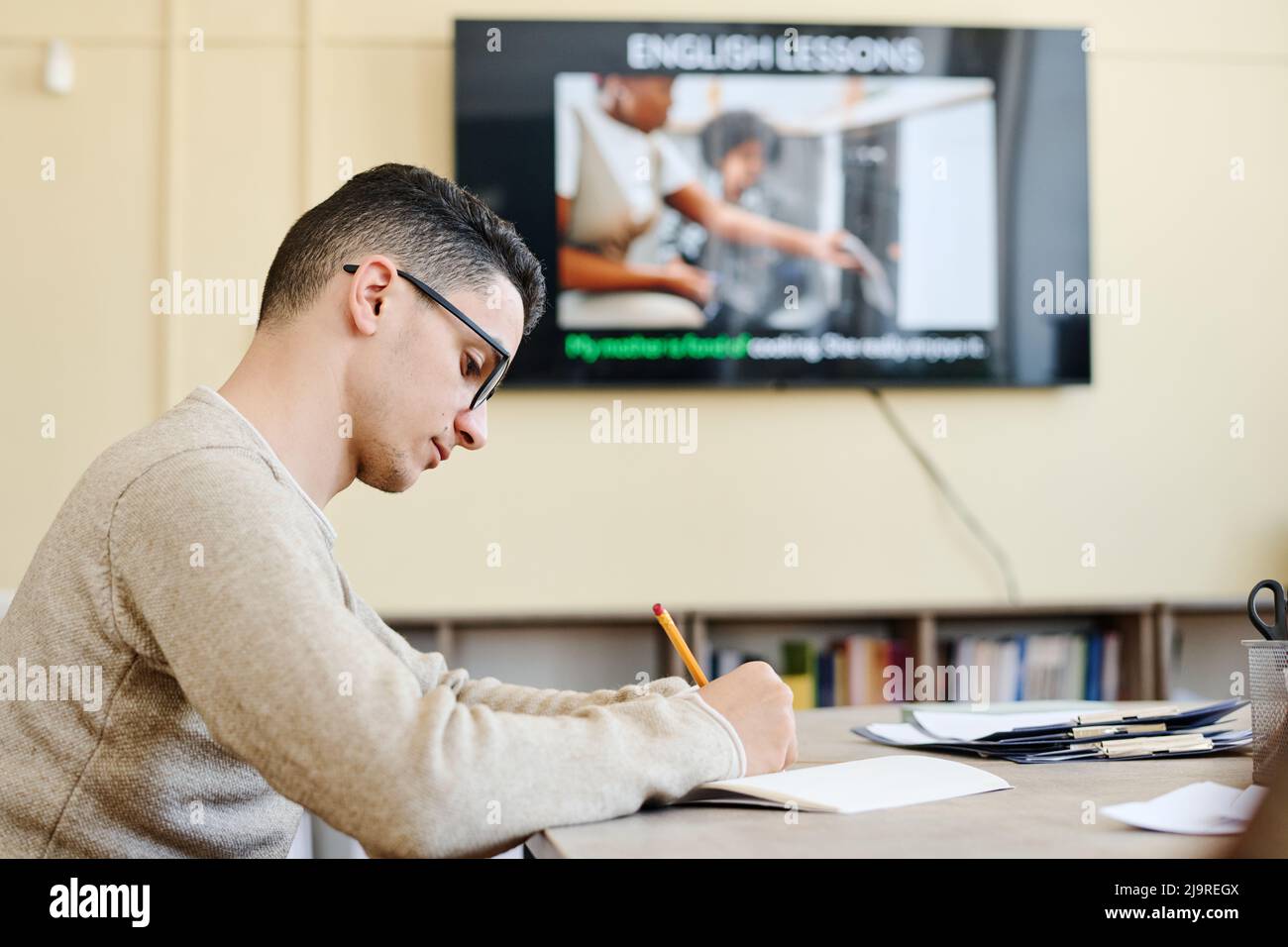 Serious young Middle Eastern man attending English language class ...