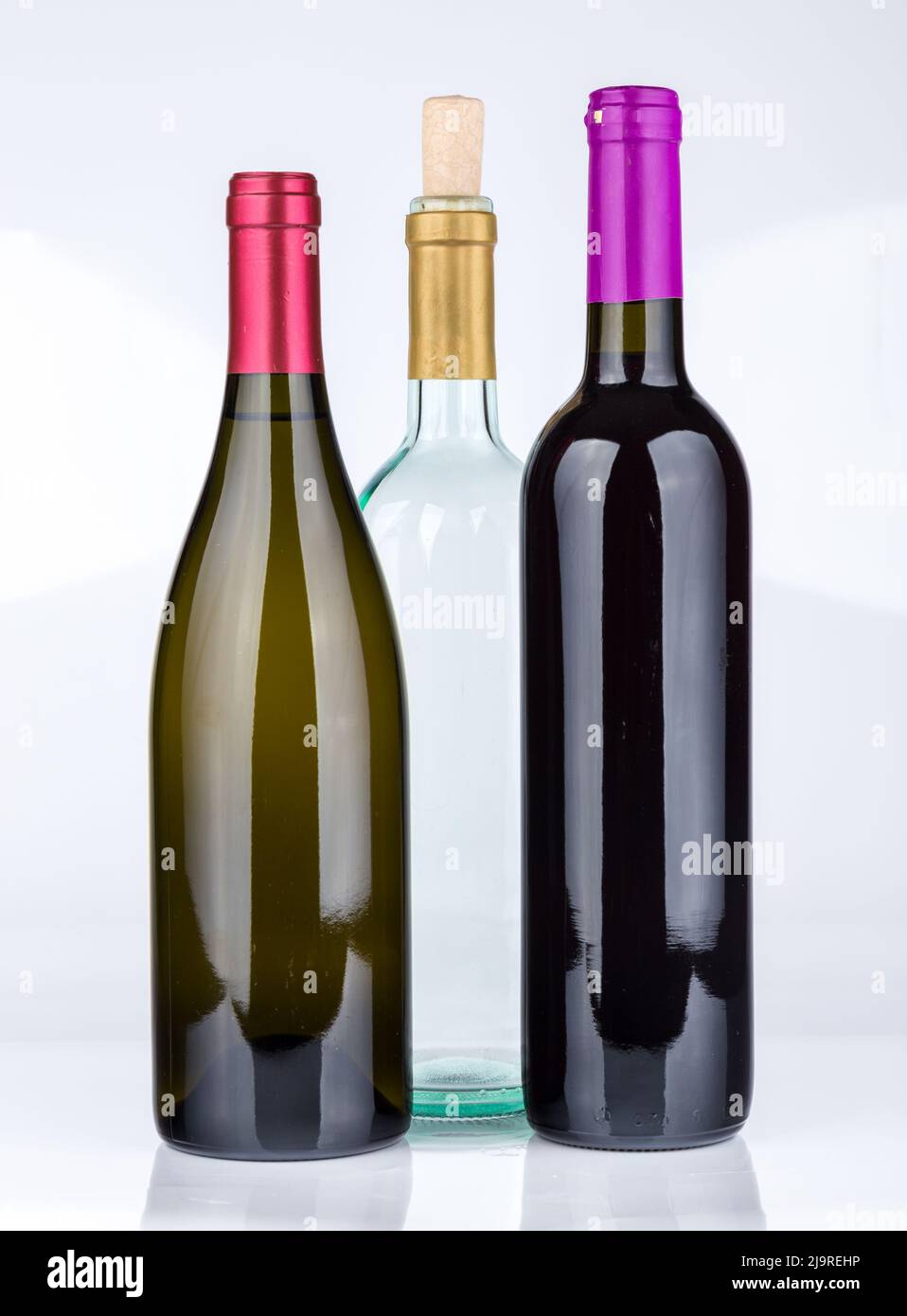 Three wine bottles isolated on white background Stock Photo - Alamy