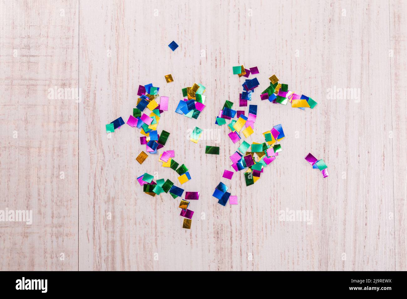 Colorful confetti on wood background scattered randomly Stock Photo - Alamy