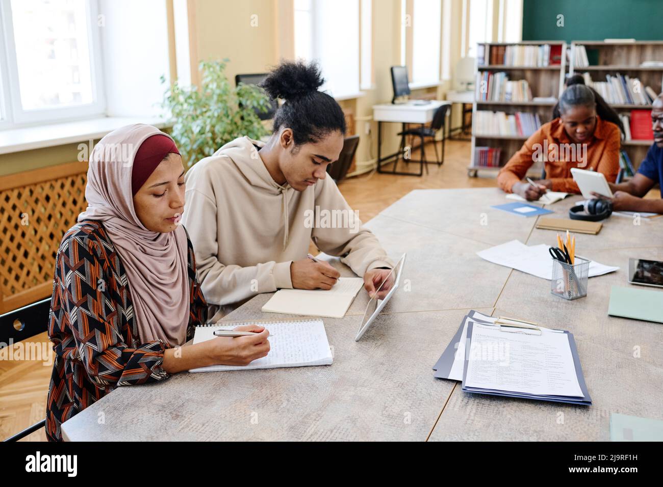 Group students table teacher hi-res stock photography and images - Alamy