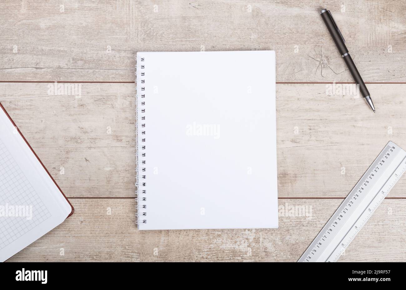 Notepad and pen on wooden table Stock Photo - Alamy