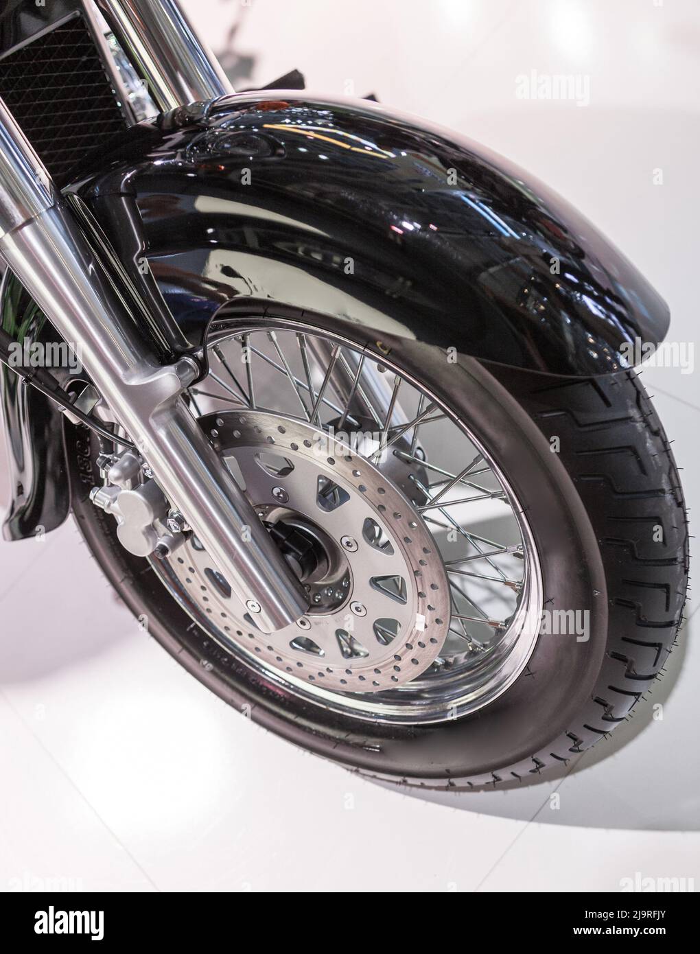 The front tire of a parked custom motorcycle Stock Photo - Alamy