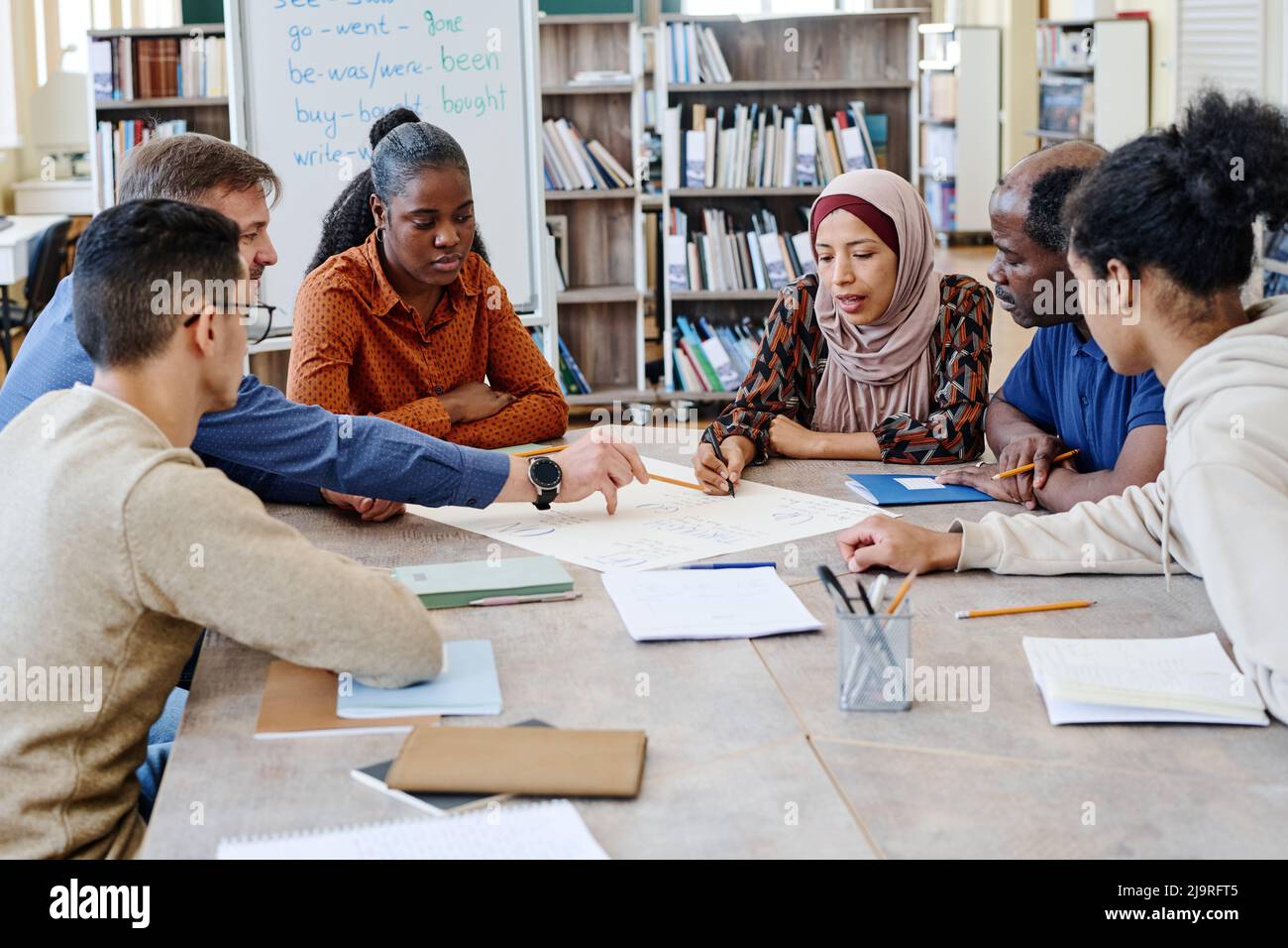 Group of multi-ethnic immigrant students attending international school ...