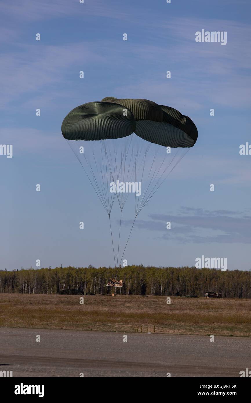 A U.S. Army M119 Howitzer lands during a heavy equipment airdrop ...