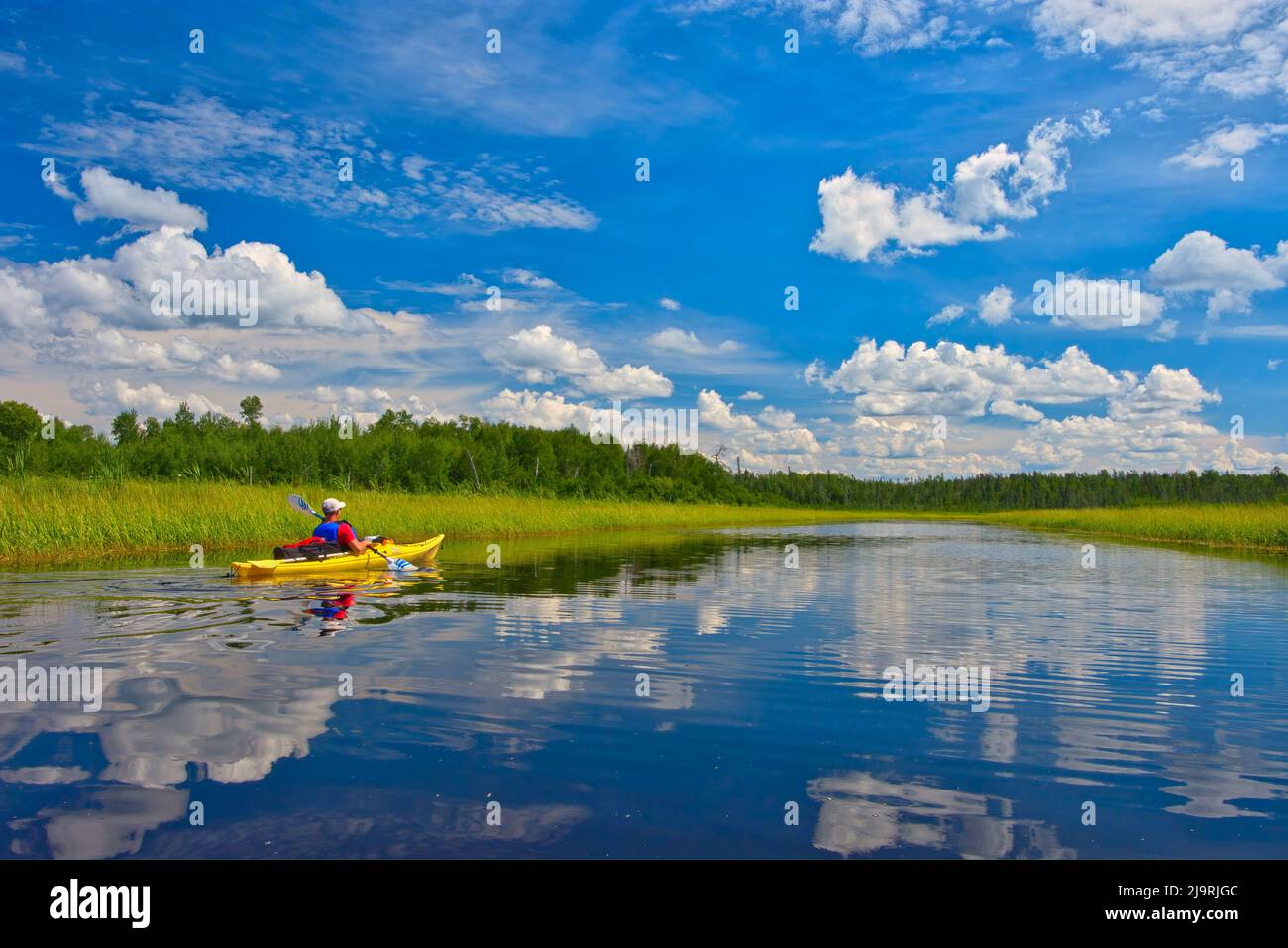 Canada, Manitoba, Whiteshell Provincial Park. Man in kayak on river ...