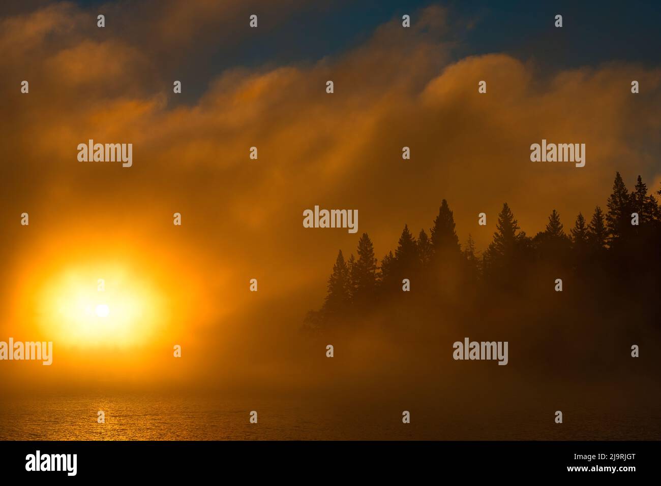 Canada, Manitoba, Whiteshell Provincial Park. Foggy sunrise over Caddy ...