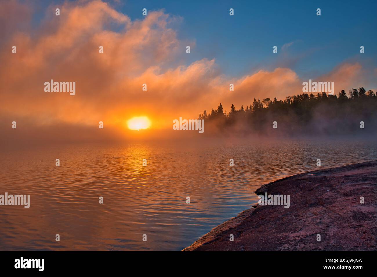 Canada, Manitoba, Whiteshell Provincial Park. Foggy sunrise over Caddy ...