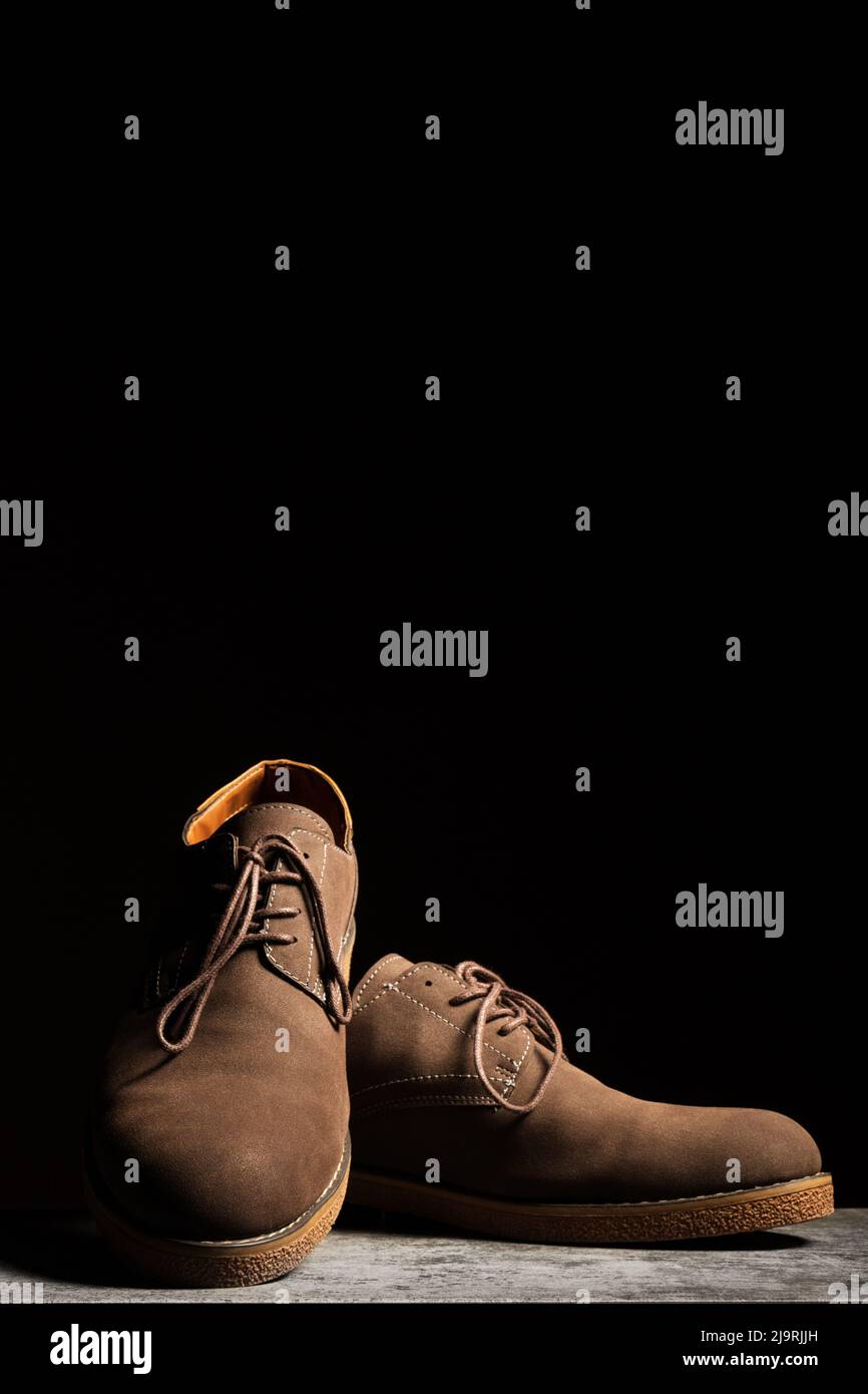 Brown shoes on a black background with vertical copy space Stock Photo ...