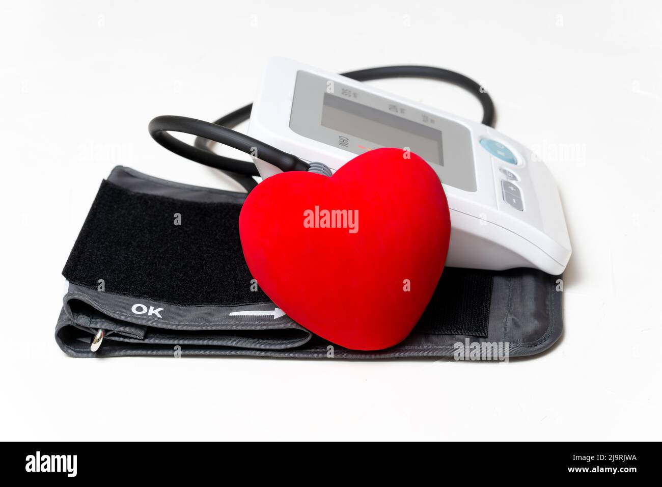 Large red heart shape on a blood pressure measuring device. Healthcare ...