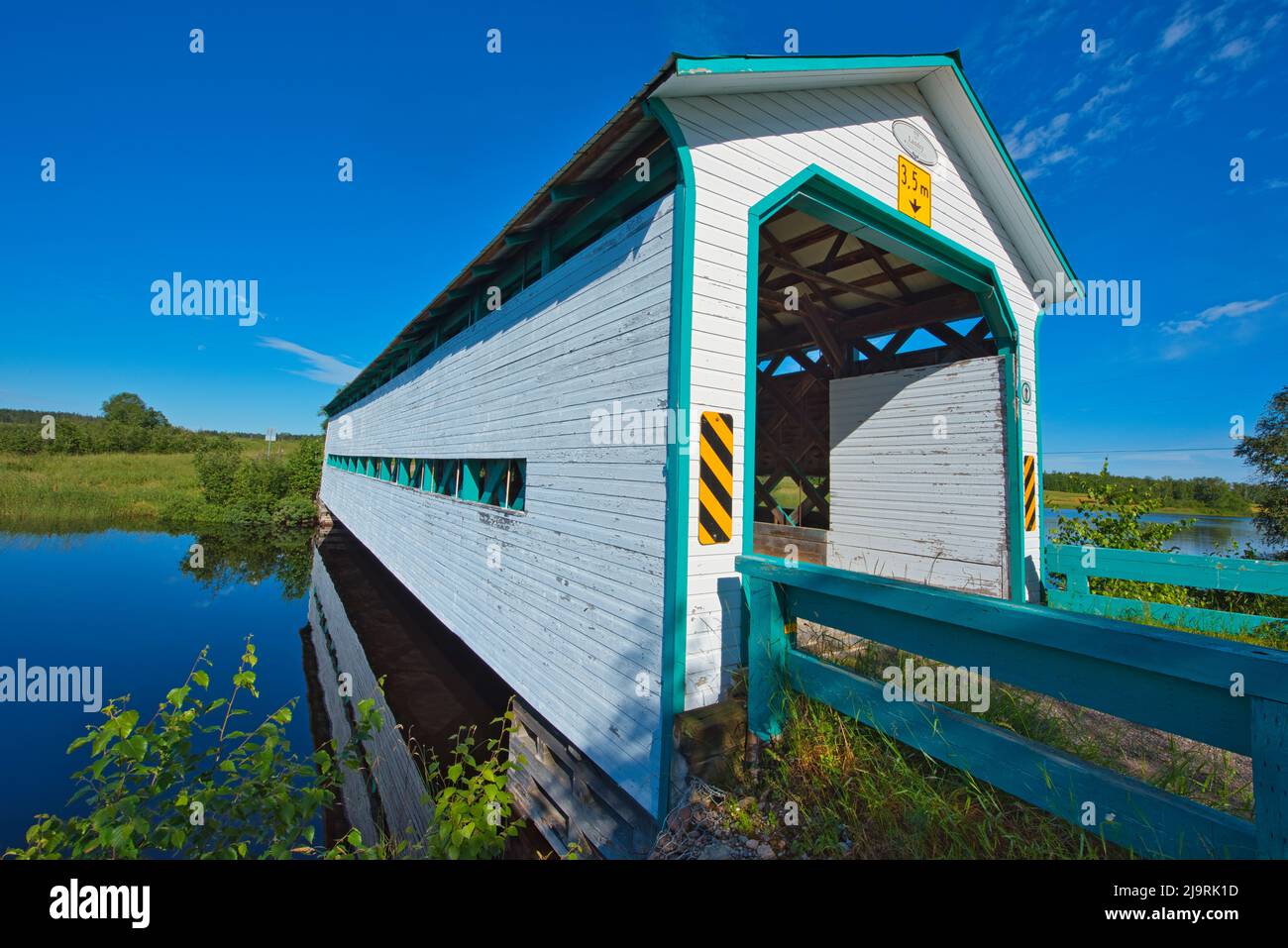 Canada, Quebec. Covered bridge crossing the Fraser River Stock Photo ...
