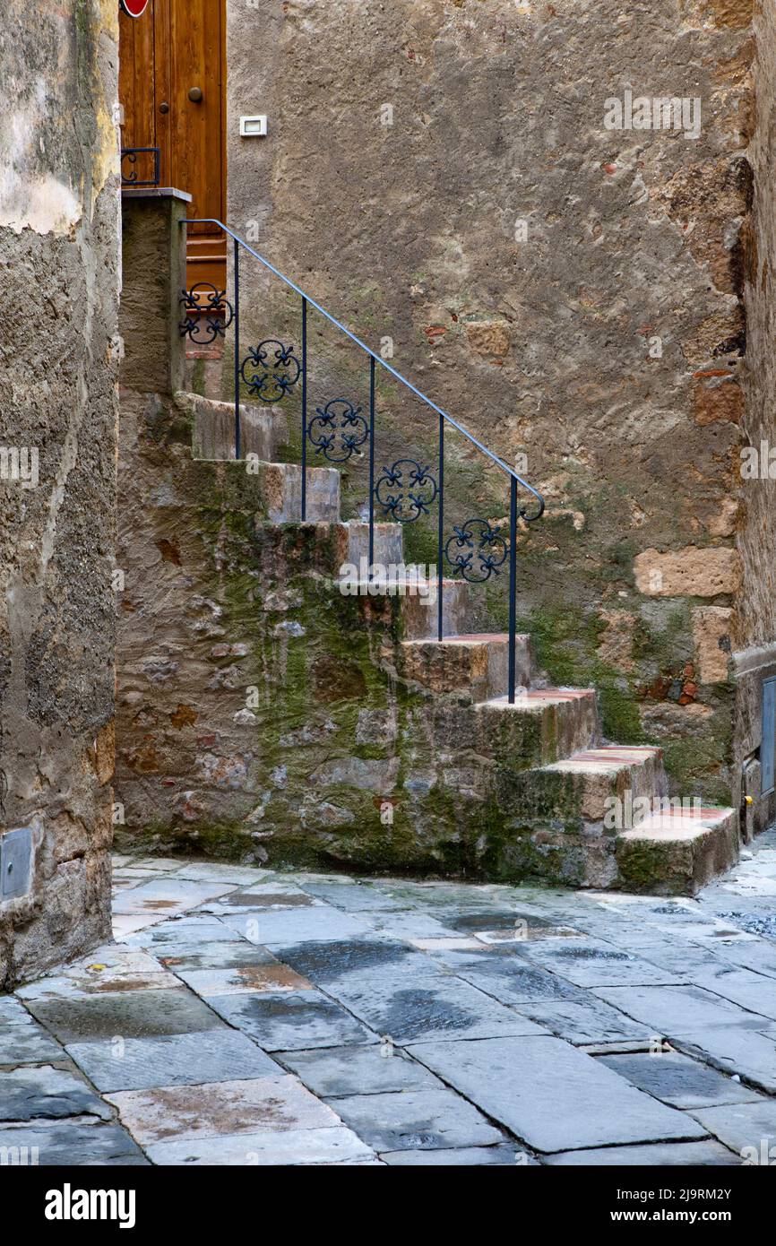 Italy, Tuscany, Pienza. Steps with wrought iron railing leading to the ...