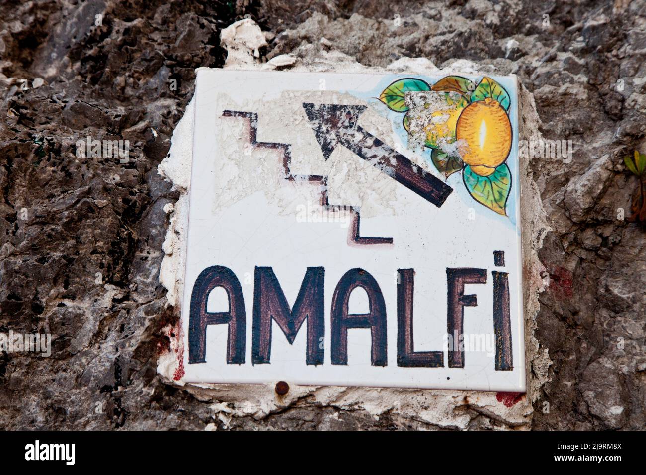 Italy, Amalfi Coastline, Atrani. Sign painted in stone leading the way ...