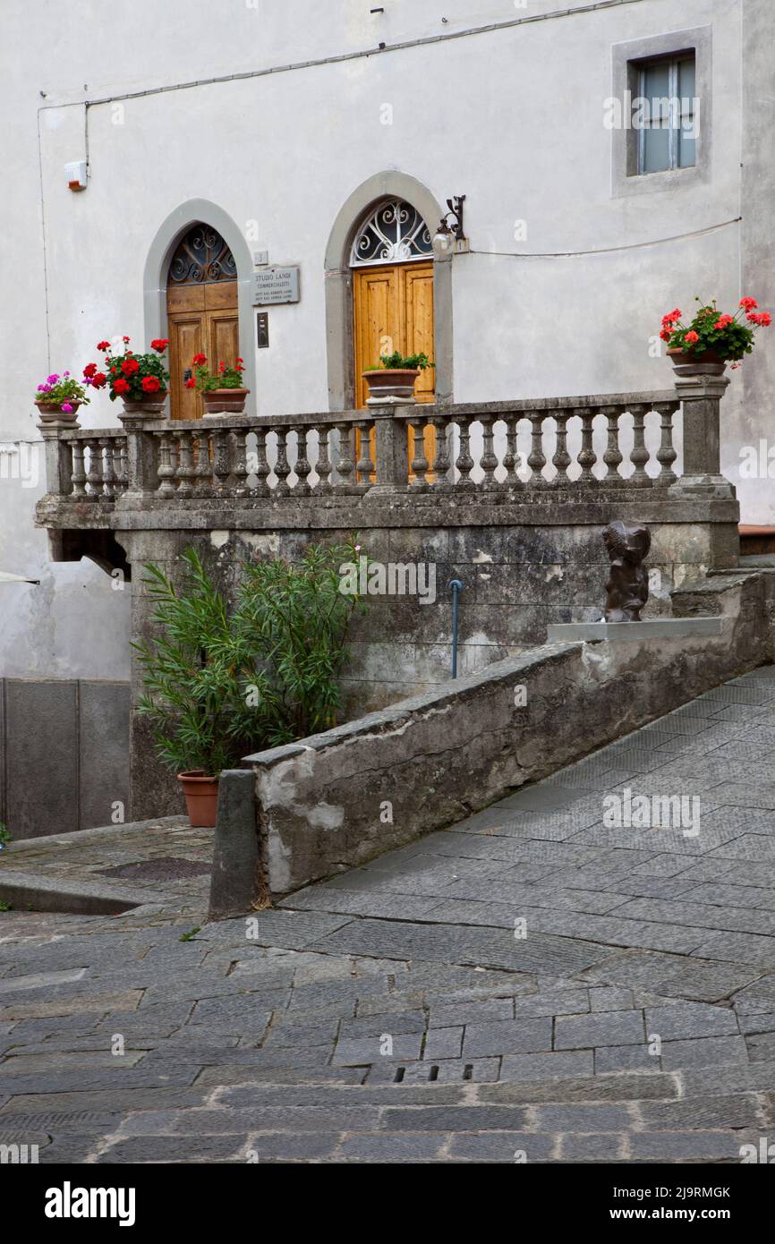 Italy, Radda in Chianti. Entrance to homes along the streets of Radda ...