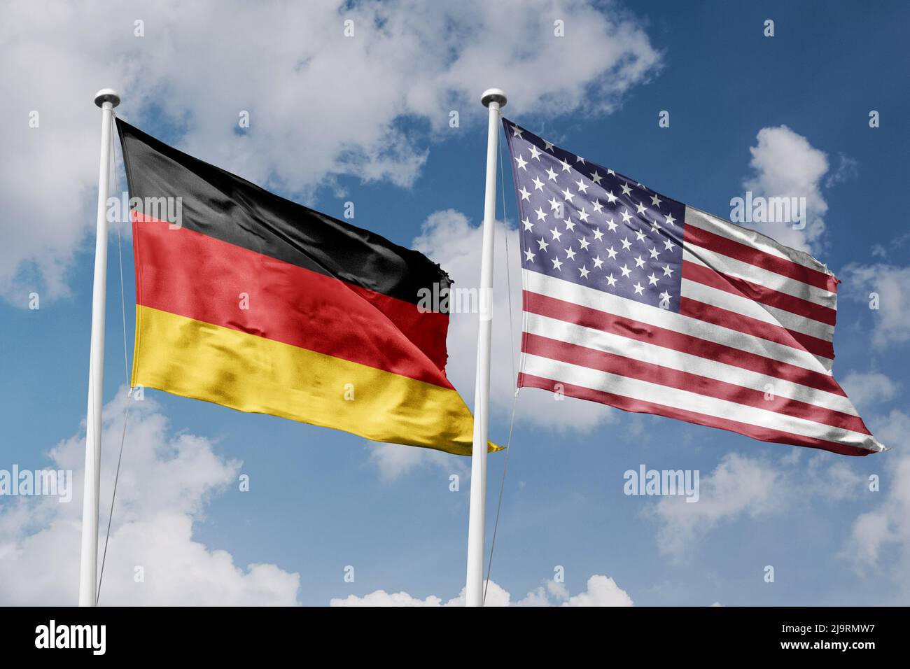 Germany and United States of America two flags on flagpoles and blue ...