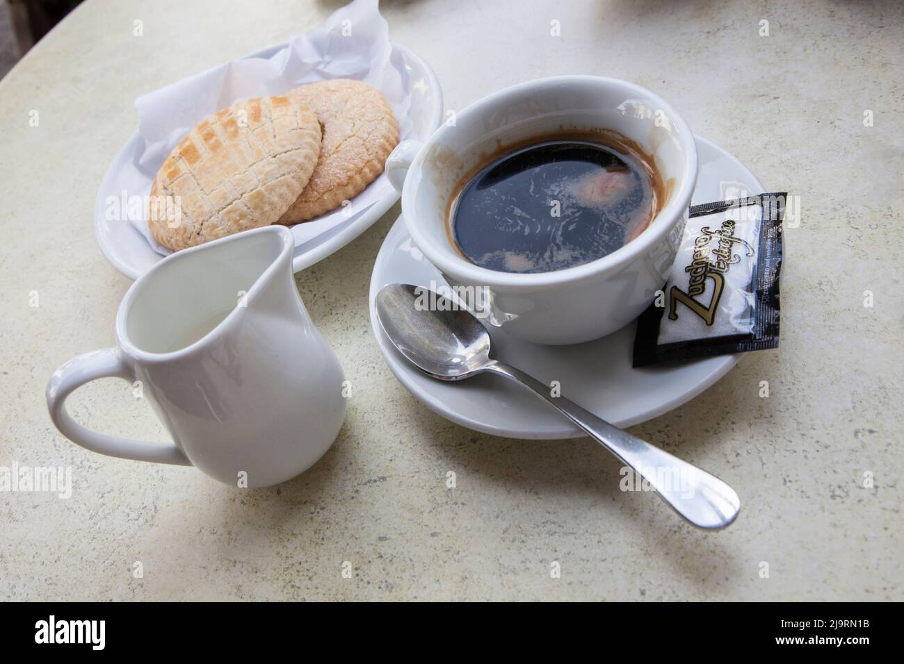 Italy, Sorrento, Amalfi Coast. Coffee with sugar and cream and cookies ...