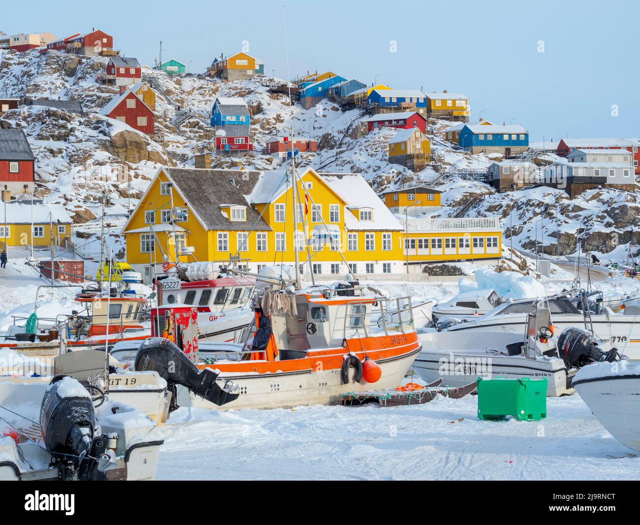 The frozen harbor of Uummannaq during winter in northern West Greenland ...