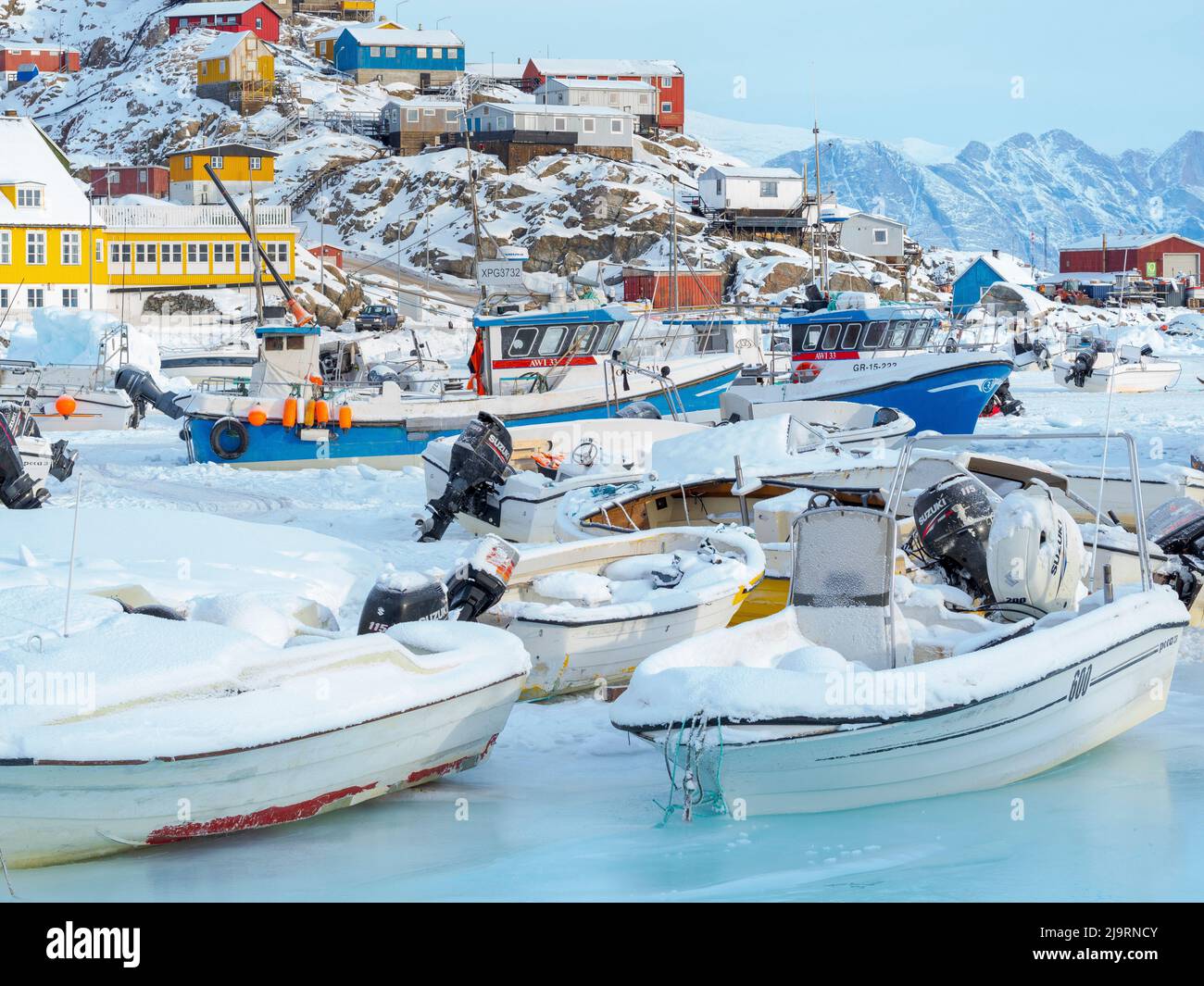 The frozen harbor of Uummannaq during winter in northern West Greenland ...